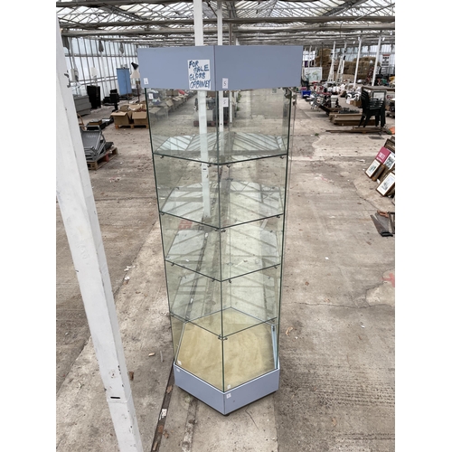 A HEXAGONAL GLASS SHOP DISPLAY UNIT WITH SHELVES