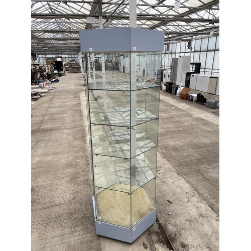 A HEXAGONAL GLASS SHOP DISPLAY UNIT WITH SHELVES