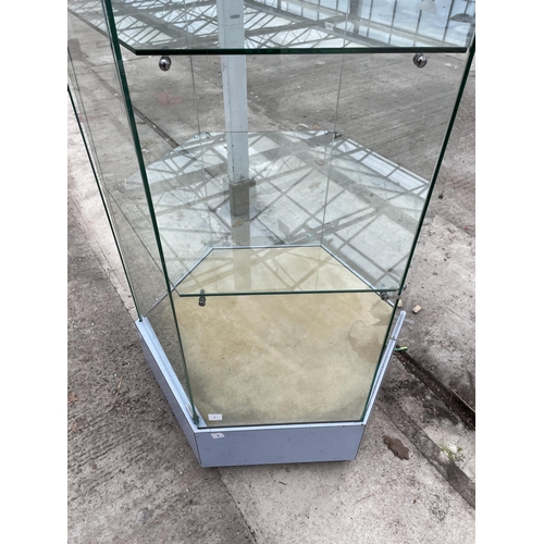 A HEXAGONAL GLASS SHOP DISPLAY UNIT WITH SHELVES