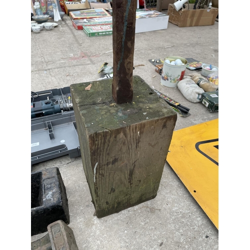 A SMALL ANVIL WITH WOODEN BLOCK BASE