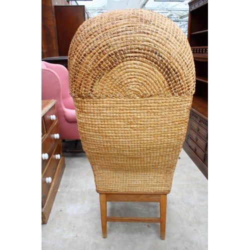 A HOODED OAK FRAMED ORKNEY CHAIR WITH WICKER SEAT AND STITCHED STRAW ...