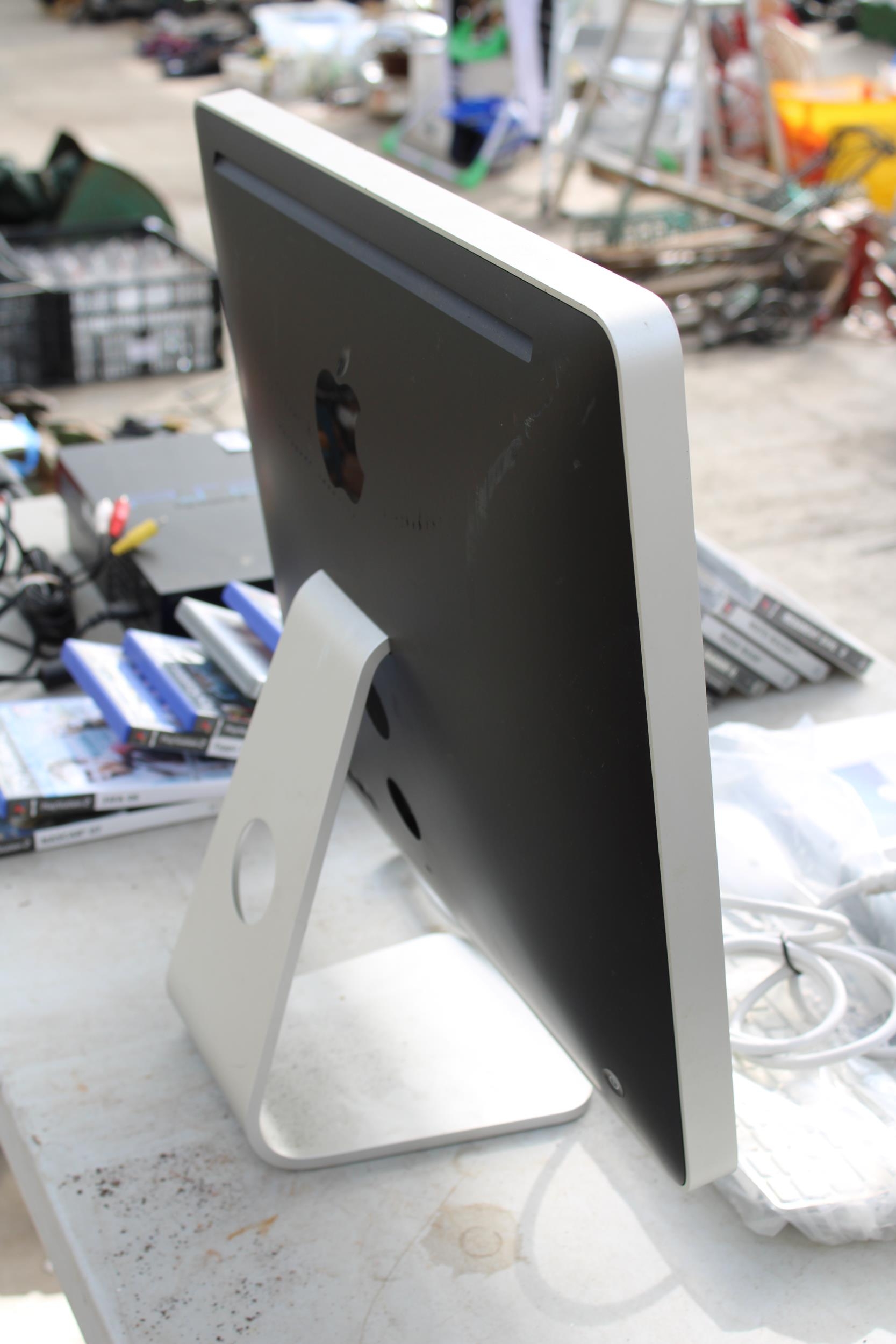 AN APPLE MAC COMPUTER, KEYBOARD, MOUSE AND MANUAL