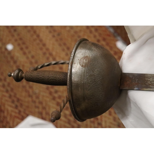 A VINTAGE SWORD WITH A BASKET HILT AND ENGRAVING TO THE TOP OF THE BLADE