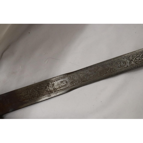A VINTAGE SWORD WITH A BASKET HILT AND ENGRAVING TO THE TOP OF THE BLADE