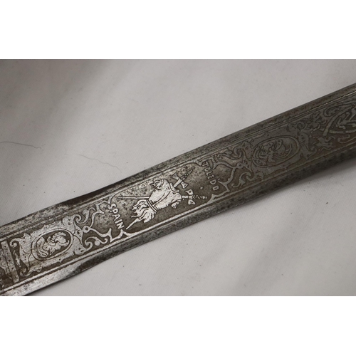 A VINTAGE SWORD WITH A BASKET HILT AND ENGRAVING TO THE TOP OF THE BLADE