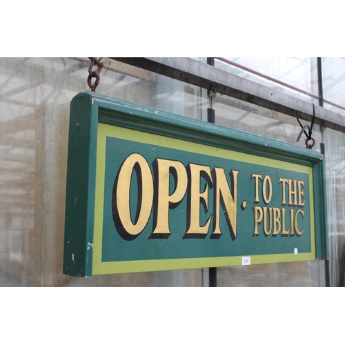 A HAND PAINTED 'OPEN TO THE PUBLIC' WOODEN SIGN