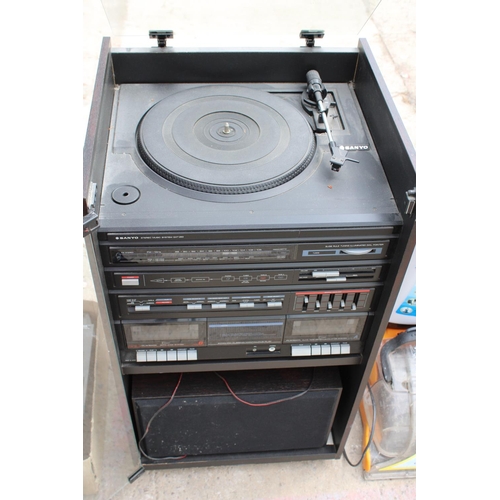 A CABINET CONTAINING A SANYO STEREO SYSTEM WITH TWO SPEAKERS