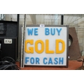 AN ILLUMINATED 'WE BUY GOLD FOR CASH' SIGN