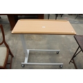 AN N.R.S. HEALTHCARE EASYLIFT OVER BED TABLE