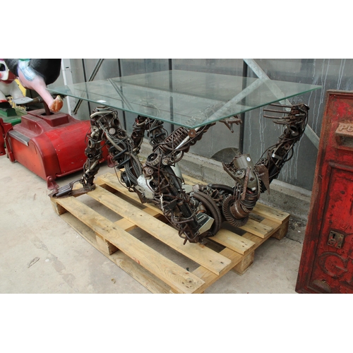 A GLASS TOPPED TABLE WITH SCRATCH BUILT MECHANIC TABLE BASE FORMED ...