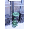 A GODIN GREEN ENAMELED CAST IRON WOOD BURNING STOVE WITH FLU PIPE