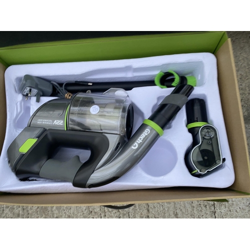A BOXED GTECH HANDHELD VACUUM WITH CHARGER AND ACCESSORIES