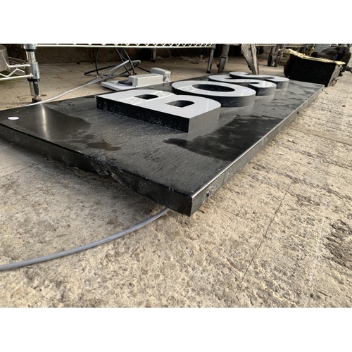 A LARGE ILLUMINATED BOSS SIGN