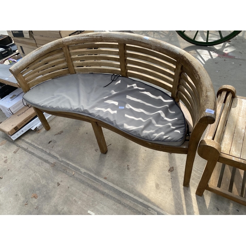 A TEAK SLATTED CURVED GARDEN BENCH WITH CUSHION