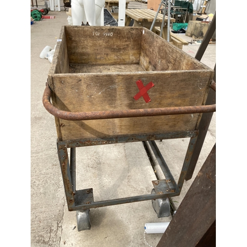 A VINTAGE MONOGRAMED GYRO BOX WITH METAL FOUR WHEELED TROLLEY BASE