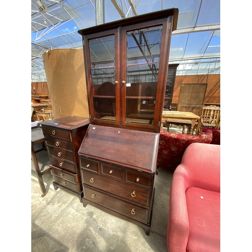 A STAG MINSTREL TWO DOOR GLAZED BOOKCASE ON BASE ENCLOSING THREE SHORT ...