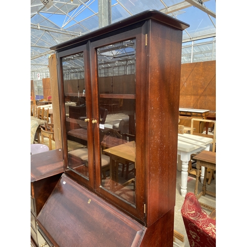 A STAG MINSTREL TWO DOOR GLAZED BOOKCASE ON BASE ENCLOSING THREE SHORT ...