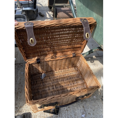 A SMALL WICKER HAMPER WITH HIINGED LID