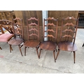 AN ERCOL SET OF FOUR BATWING DINING CHAIRS