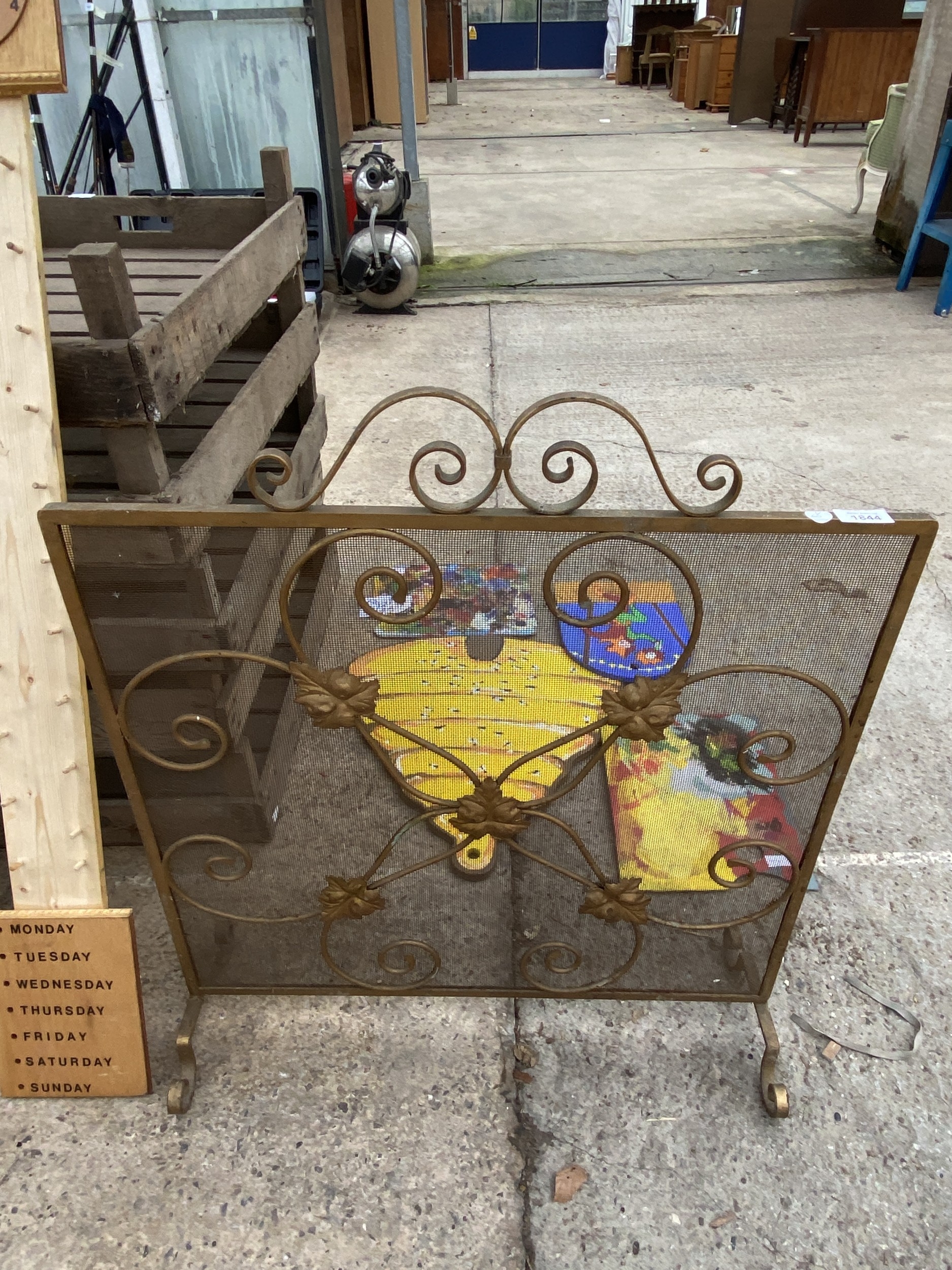 A DECORATIVE BRASS FIRE SCREEN