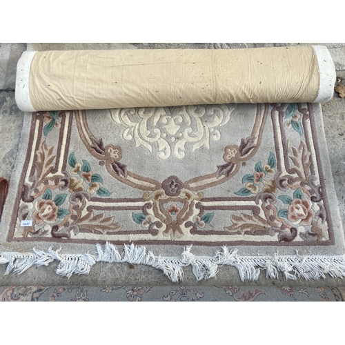A CREAM PATTERNED FLORAL RUG