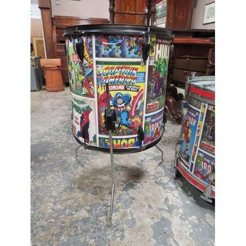 A GLASS TOPPED COMIC BASE DRUM TABLE TOGETHER WITH ANOTHER FLOOR ...