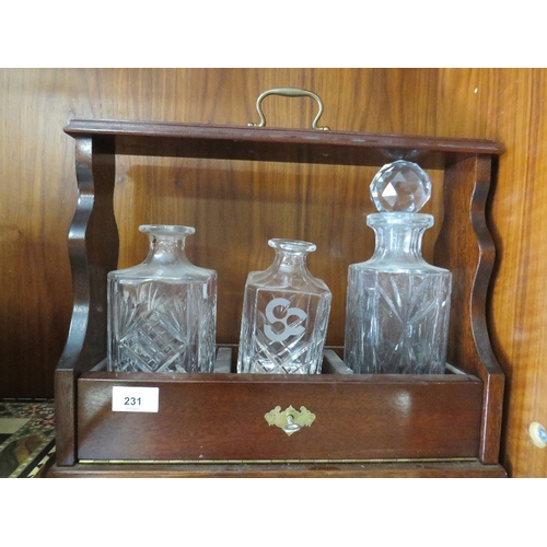 A modern three bottle tantalus and part contents