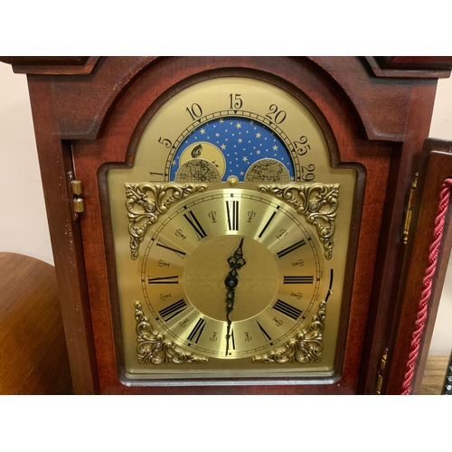 A modern moon roller triple weight long case clock made by Interclock ...