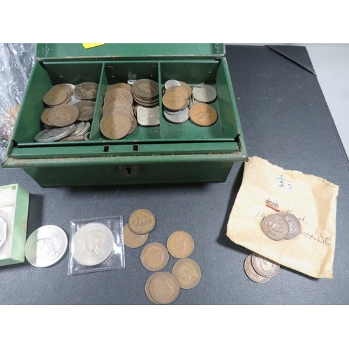 A vintage tin cash box of coins