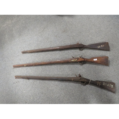 Two antique long bore flintlock rifles together with a pin fire rifle A ...
