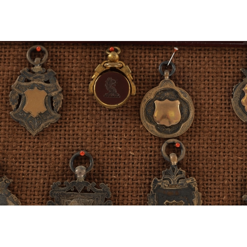 A COLLECTION OF FIFTY-EIGHT SILVER AND METAL POCKET WATCH FOBS of ...