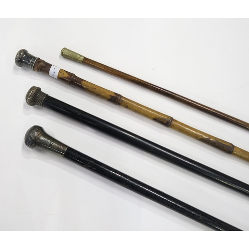 Two silver-topped ebonised walking canes, a silver-topped bamboo cane ...