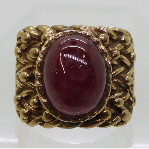 A 9ct gold gents ring set with a large glass bonded ruby, size U1/2 ...