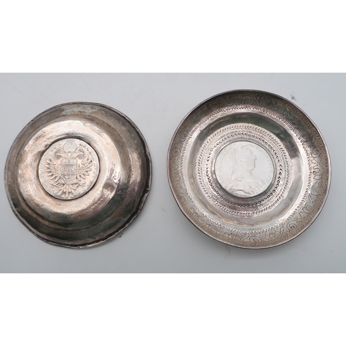 A collection of white metal coin dishes, inset with 1780 Thalers, a ...
