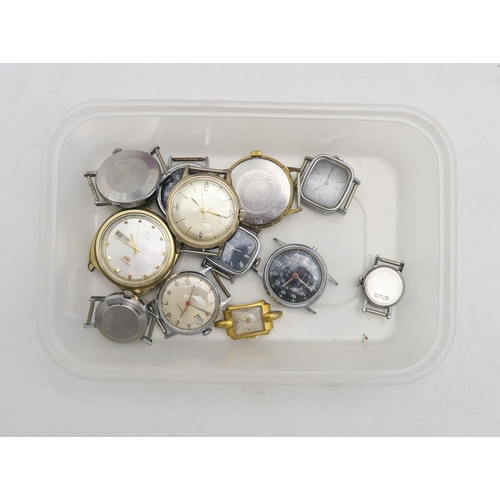 A quantity of vintage watch heads, movements and other components ...