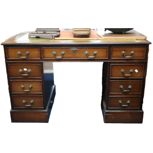 A 20th century mahogany pedestal writing desk with embossed skiver top ...