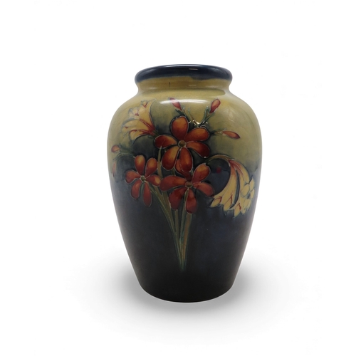 A WILLIAM MOORCROFT SPRING FLOWERS VASEthe dark blue and cream ground ...