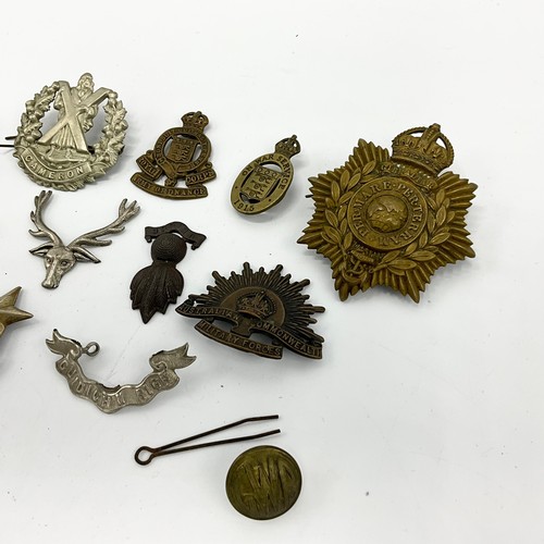A collection of military cap badges, to include Cameroonian rifles ...