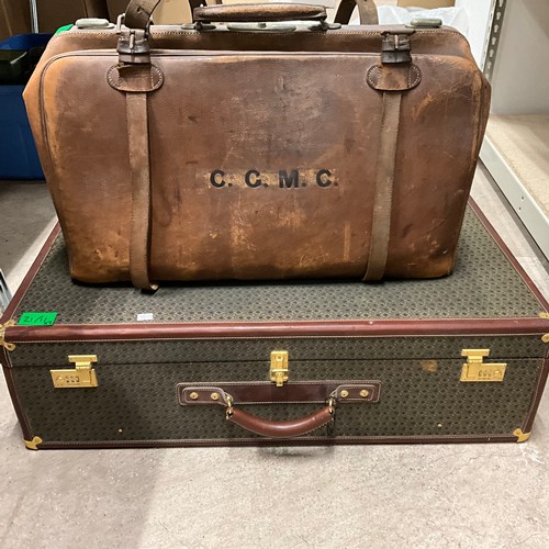 Large travel trunk along with leather bag.