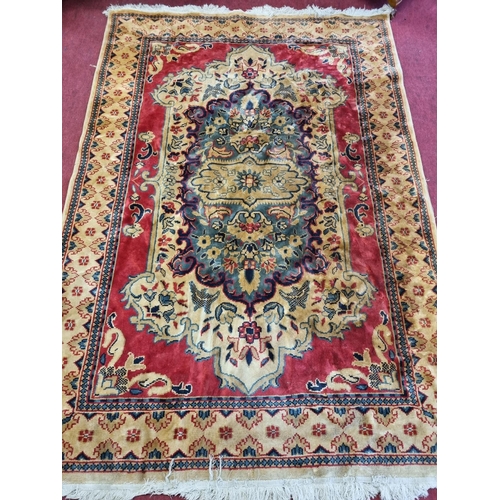 A cream ground Carpet with a blue and red central decoration. 270 x 182 ...