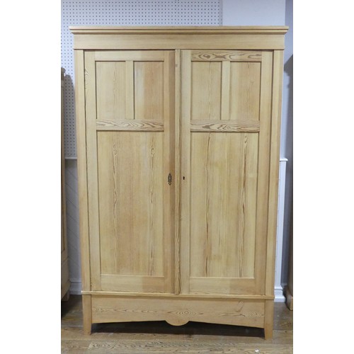 An antique pine double Wardrobe, with panel doors and shaped apron, W ...