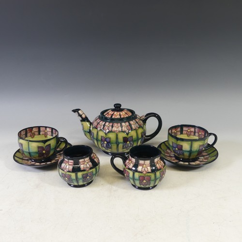A Moorcroft 'Violet' pattern Tete-a-Tete Tea Set, designed by Sally ...