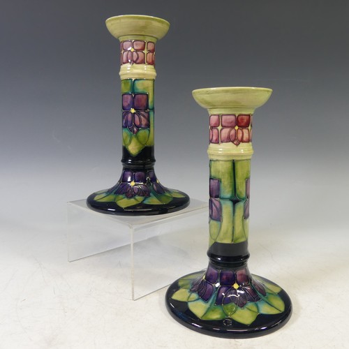 A pair of Moorcroft 'Violet' pattern Candlesticks, with tubelined ...