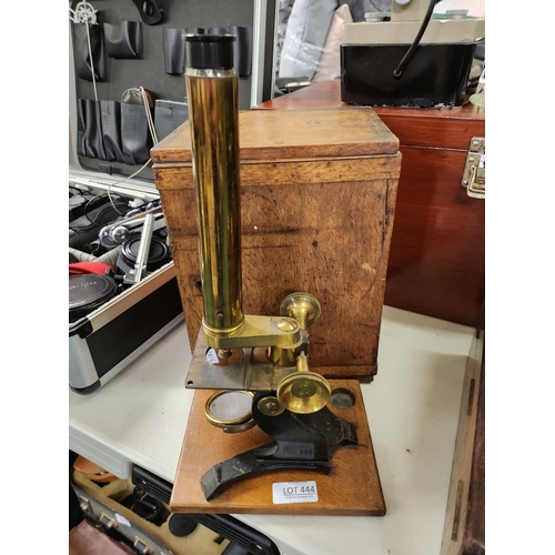 AN ANTIQUE BRASS AND METAL MICROSCOPE WITH CASE