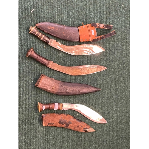 3 VINTAGE KUKRI KNIVES EACH WITH LEATHER SHEATH ONE WITH LIONS HEAD POMMEL