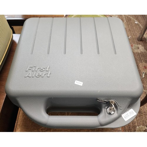 A FIRST ALERT FIRE SECURITY BOX WITH 2 KEYS