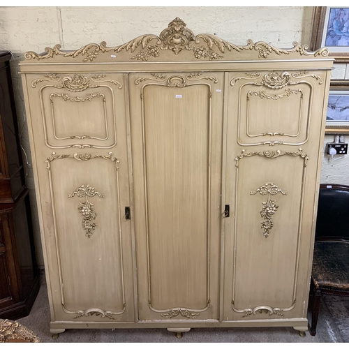 A LOUIS STYLE IVORY COLOURED ROCOCO TRIO WARDROBE WITH FLORAL FRIESE ...