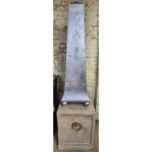 AN UNUSUAL SILVER PAINTED OBELISK ON BALLED FEET ABOVE A SINGLE ...