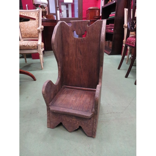 A child's oak settle chair, 64cm high x 32cm wide x 36cm deep
