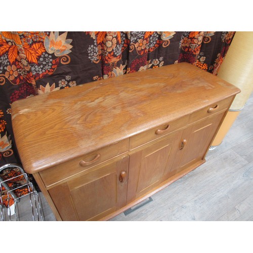 A Priory oak small side cabinet with three cupboard doors and three ...